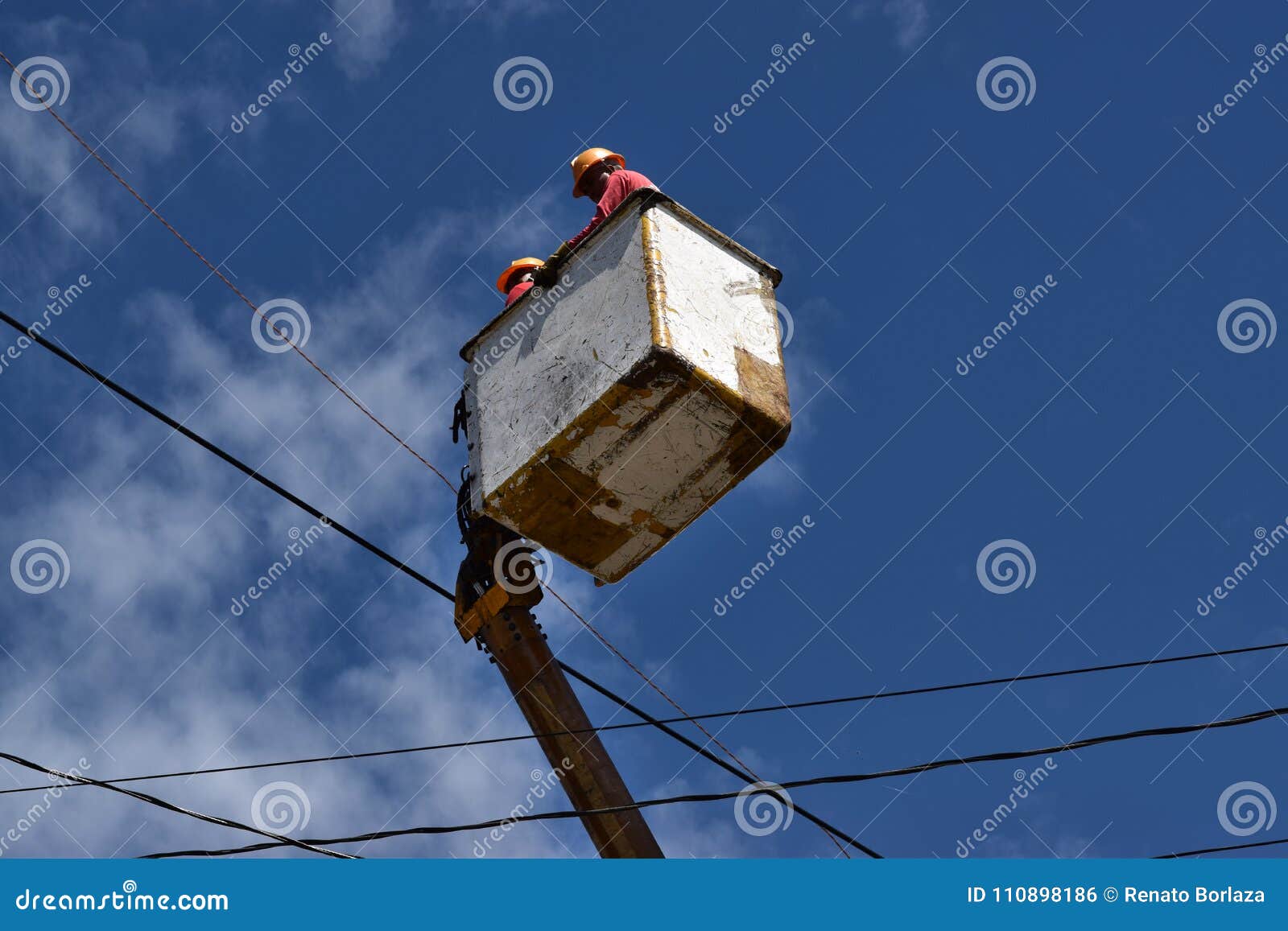 Electrical Workers On Telehandler With Bucket Installing High Tension ...