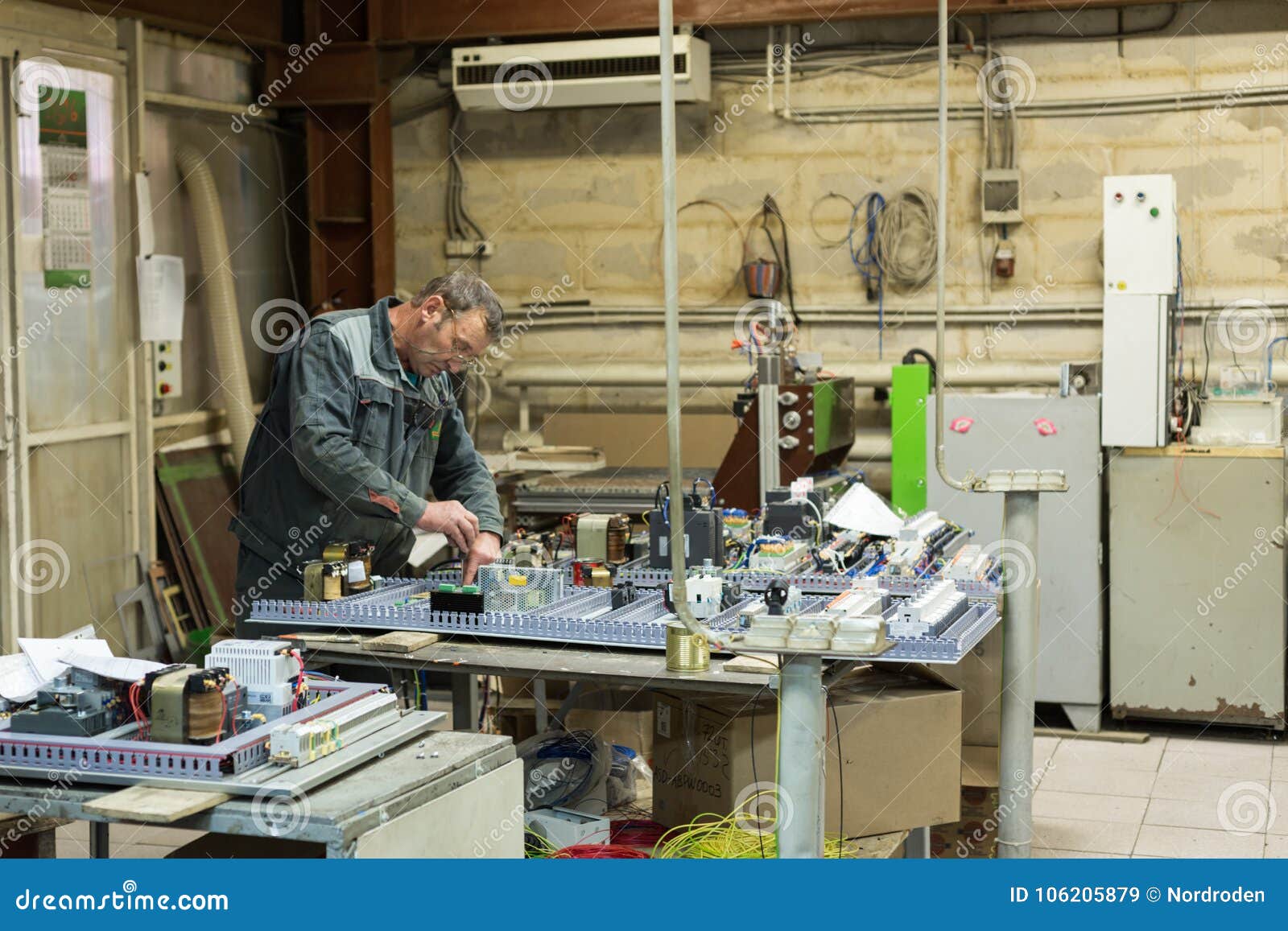 The Electrician Assembles and Adjusts the Electrical Control Panel ...