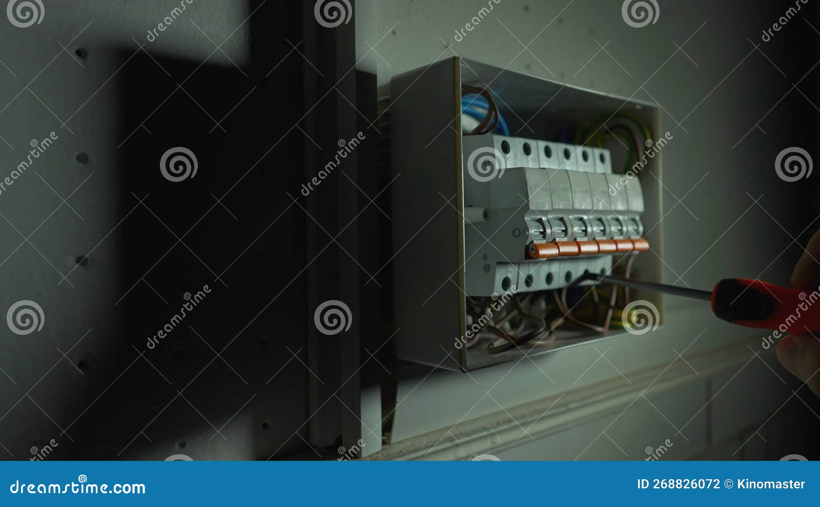 Electrician Assembles Electrical Panel in Dark by Light of Flashlight ...