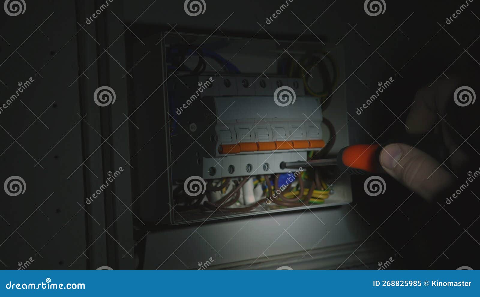 Electrician Assembles Electrical Panel in Dark by Light of Flashlight ...