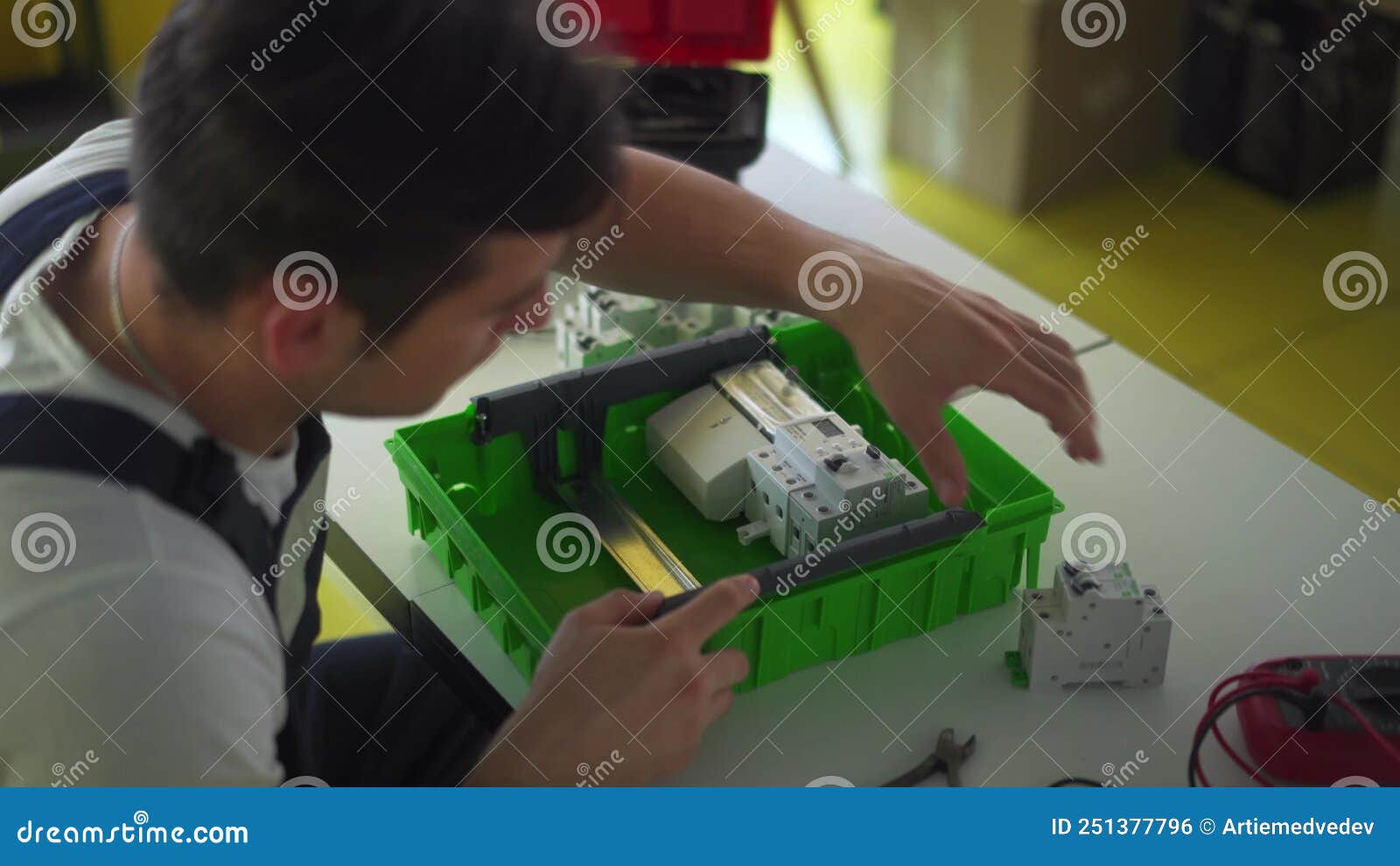Electrician Assembles Electrical Panel Fuse Box in Workshop. Worker ...