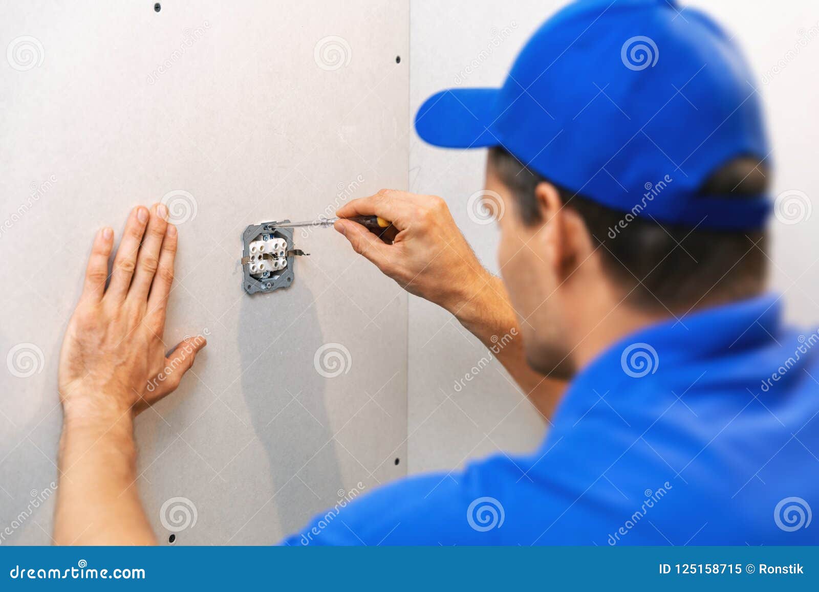 Electrician Installing Electrical Outlet on the Wall Stock Image ...