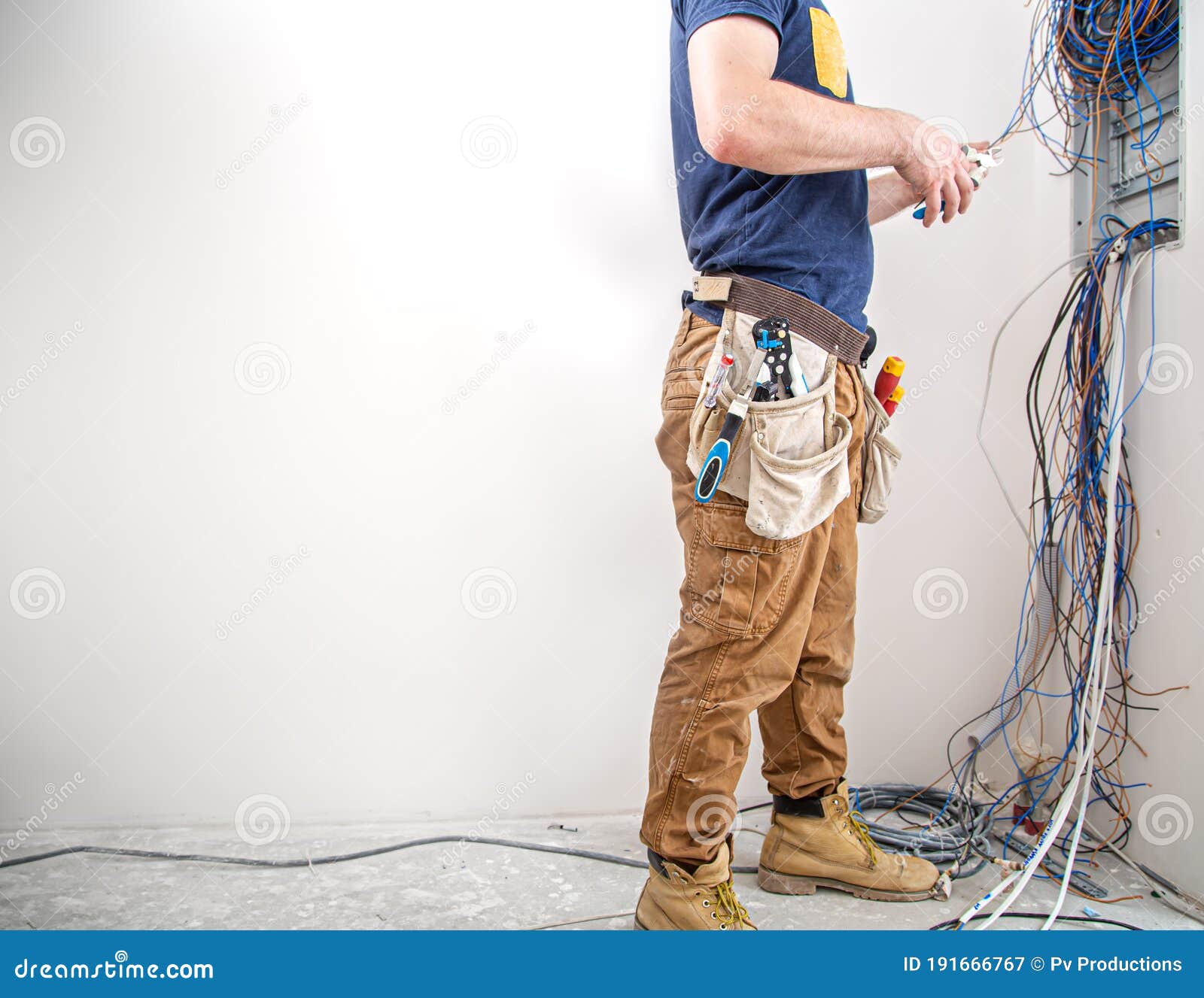 Electrician Builder at Work, Examines the Cable Connection in the ...
