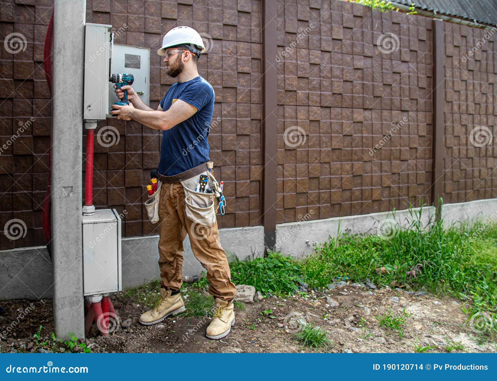 Electrician Builder at Work, Examines the Cable Connection in the ...