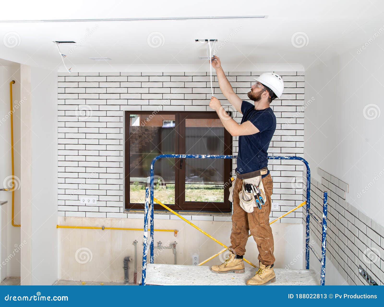 Electrician Builder at Work, Installation of Lamps at Height ...