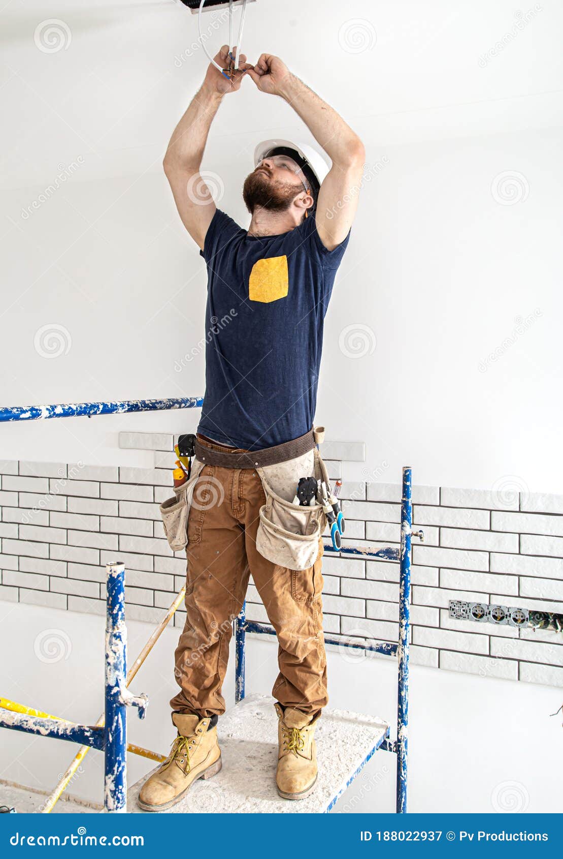 Electrician Builder at Work, Installation of Lamps at Height ...