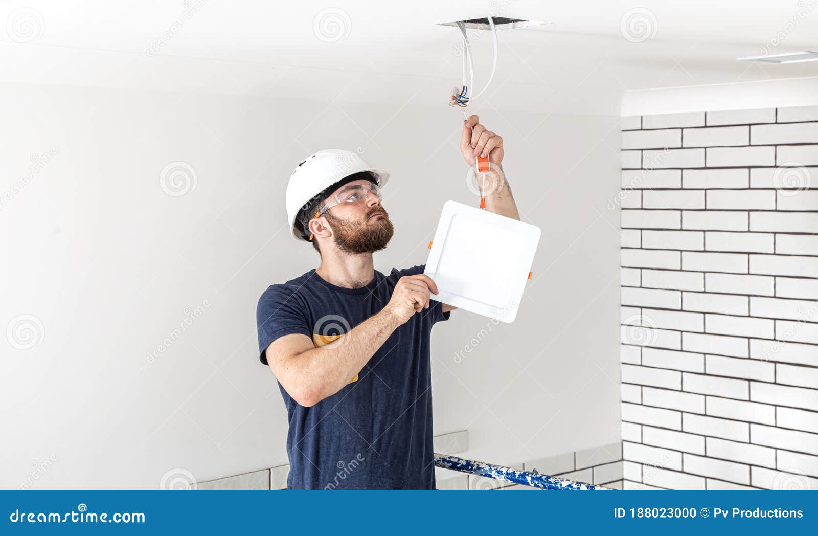 Electrician Builder at Work, Installation of Lamps at Height ...