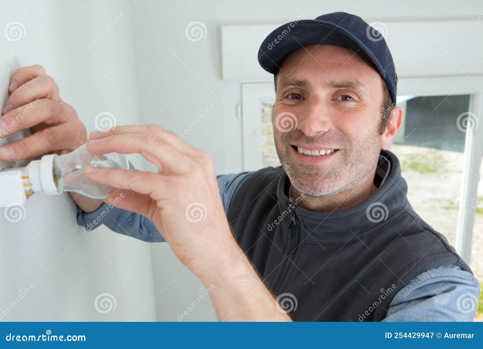 Electrician Changing Light Bulb in Wall Lamp Stock Image - Image of ...