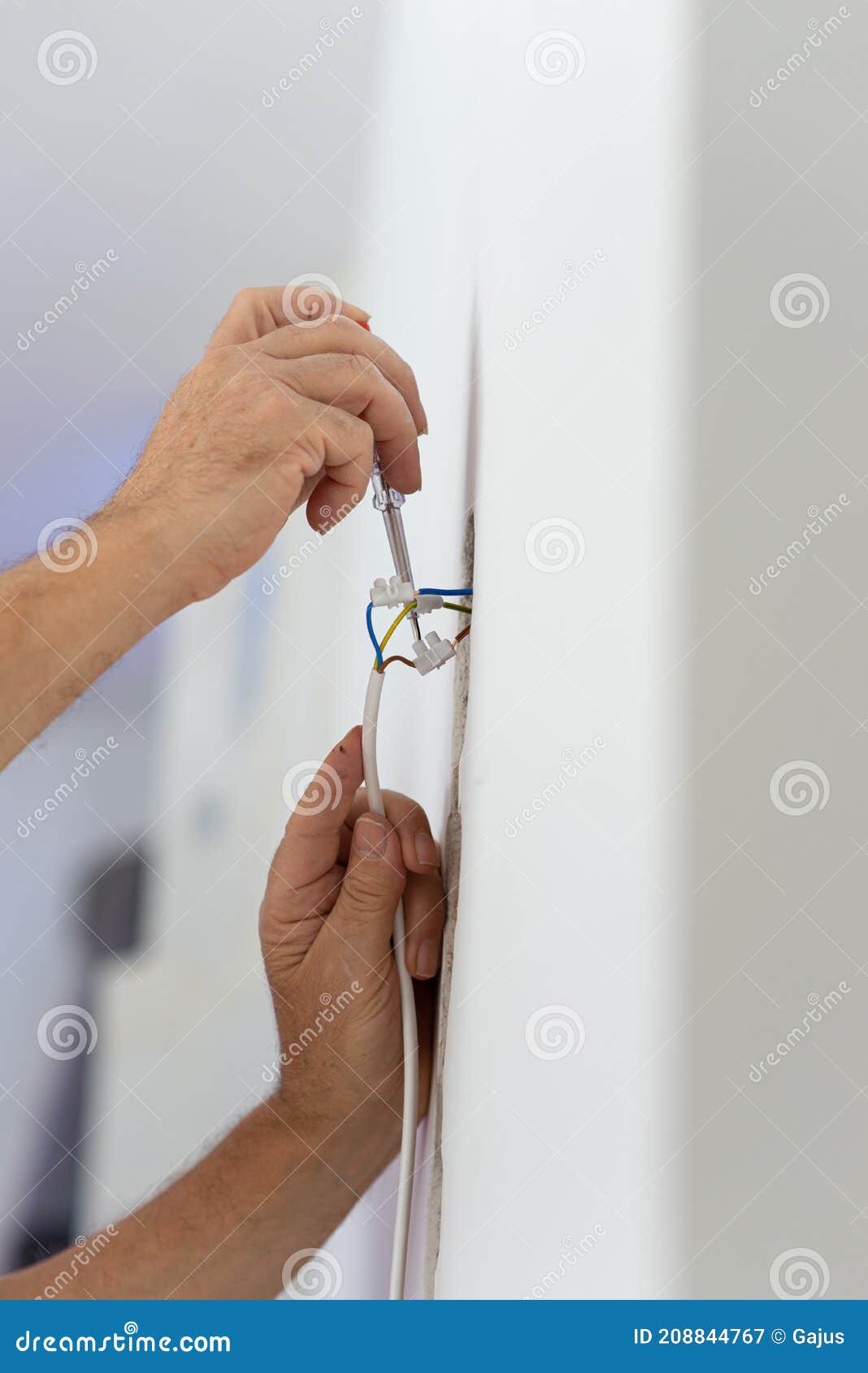 Electrician Checking the Presence of Electrical Current in the Wires ...