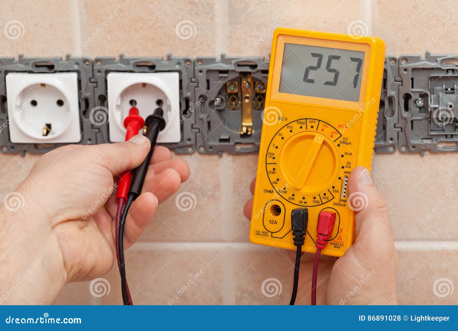 Electrician Checking Voltage in a Partially Installed Electrical Stock ...