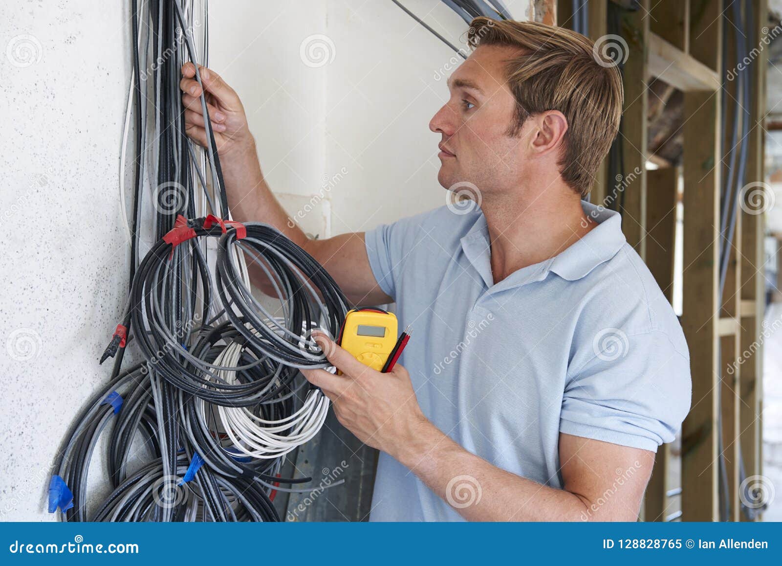 Electrician Fitting Wiring on Construction Site Stock Image - Image of ...