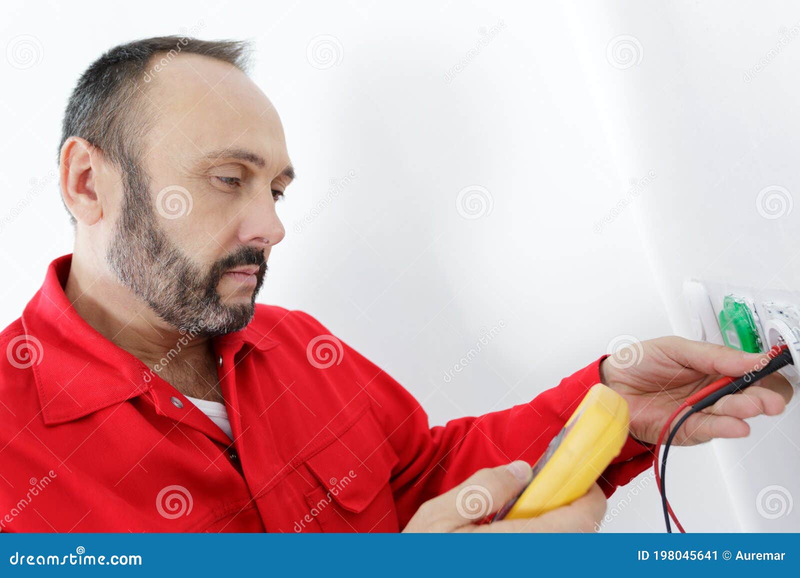 The Guy Checks The Voltage In The Disassembled Electrical Outlet With A ...