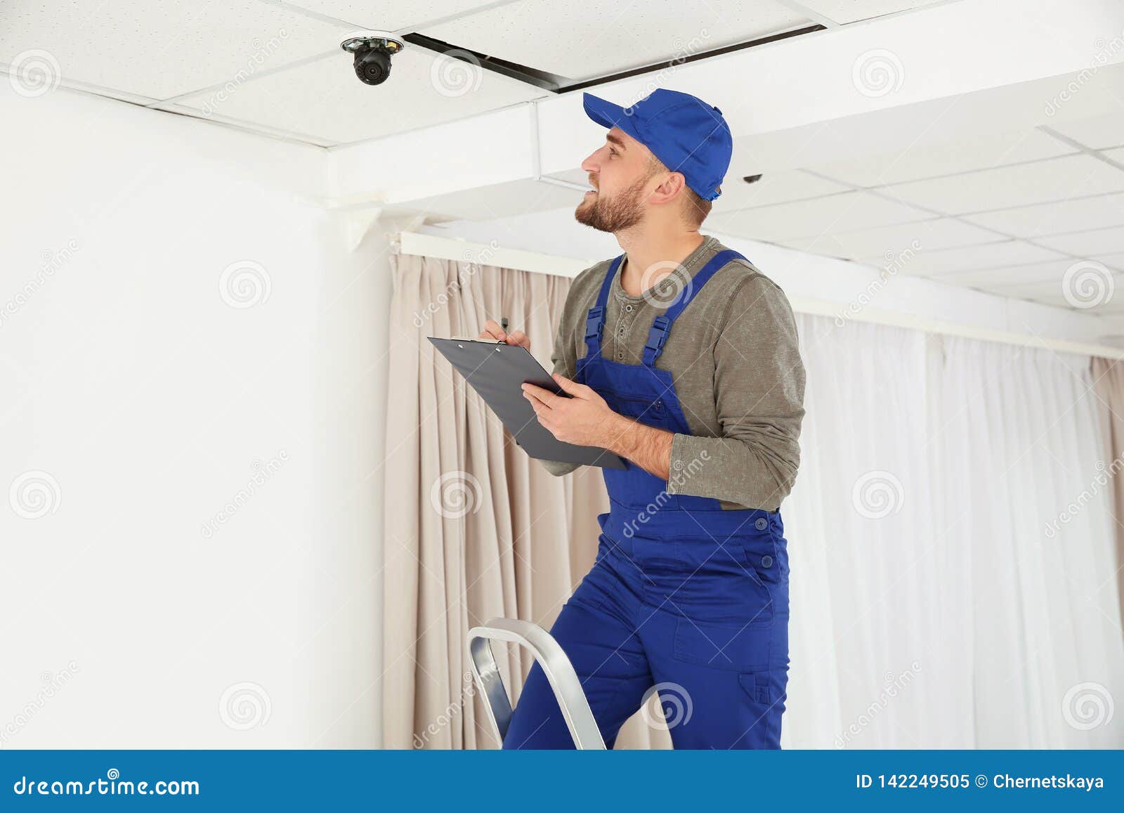 Electrician with Clipboard Checking Camera Stock Image - Image of ...