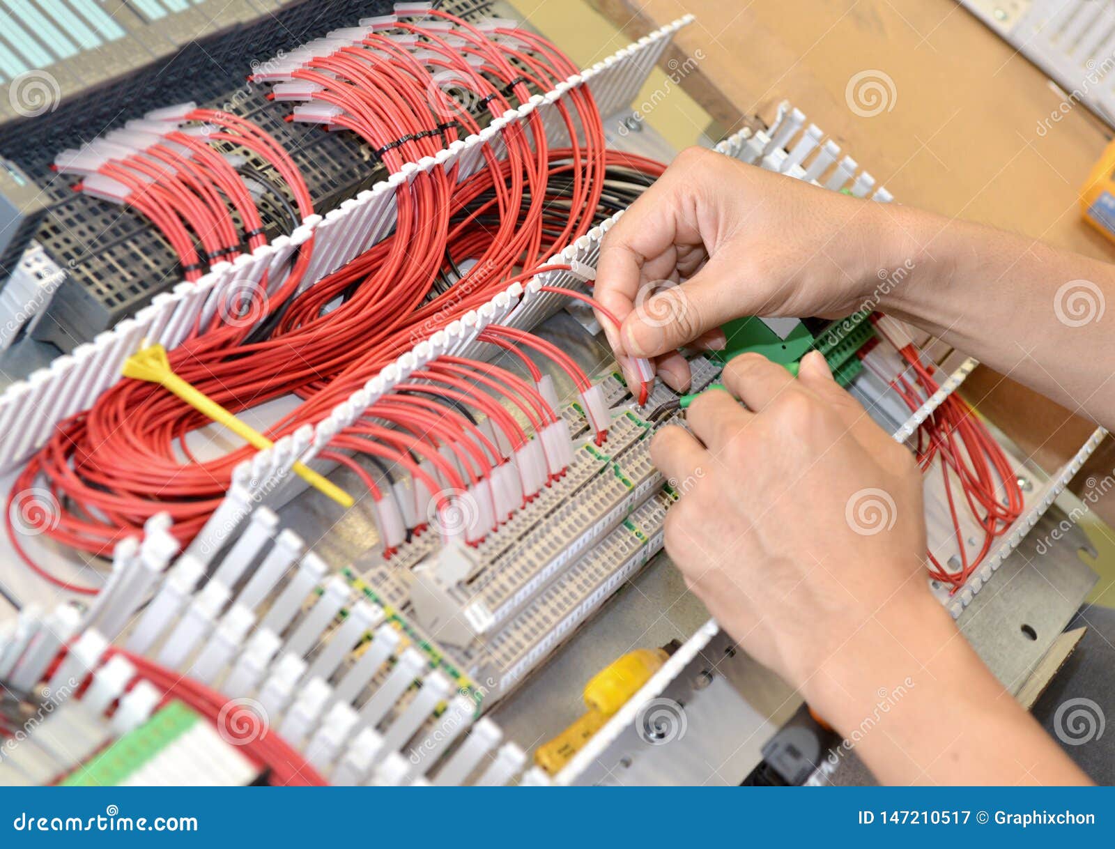 The Electrician is Connecting the Electric Cable Wire. Stock Image ...