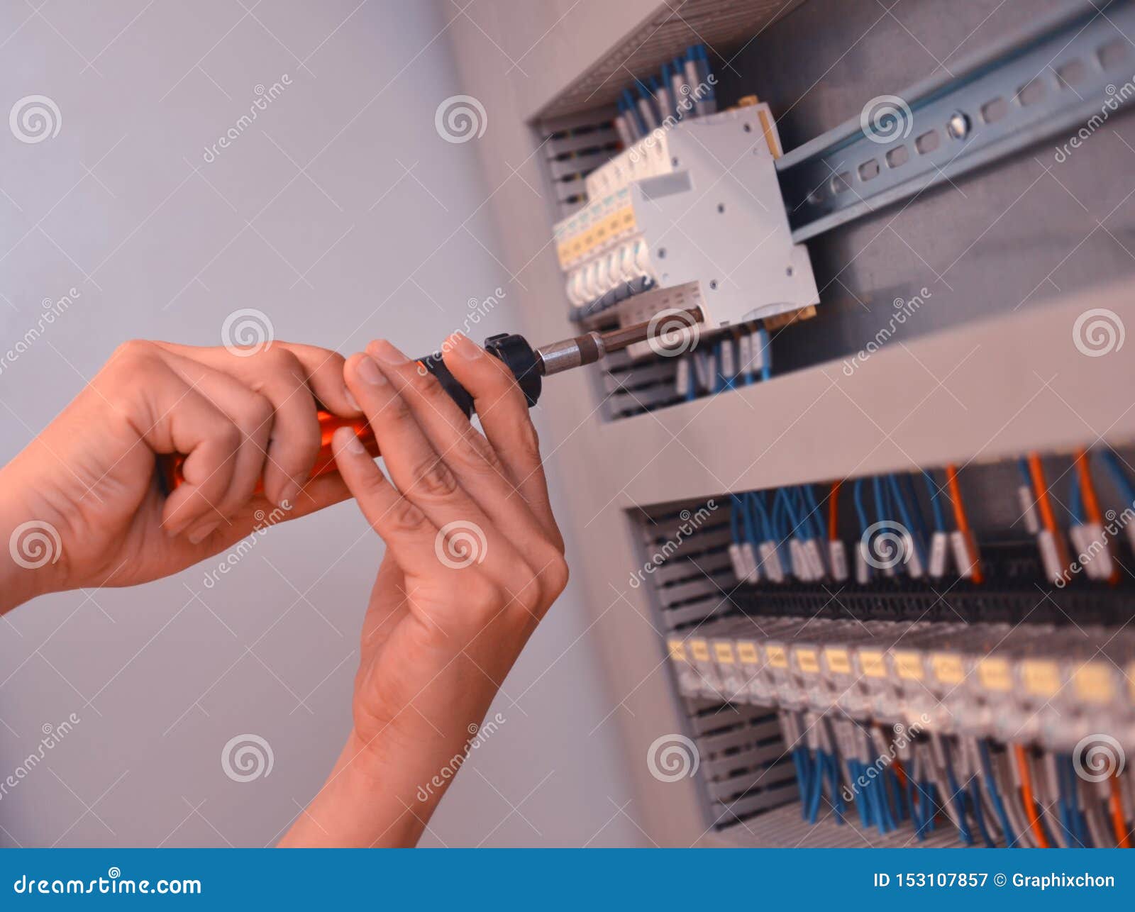 The Electrician is Connecting the Electric Cable Wire. Engineer ...