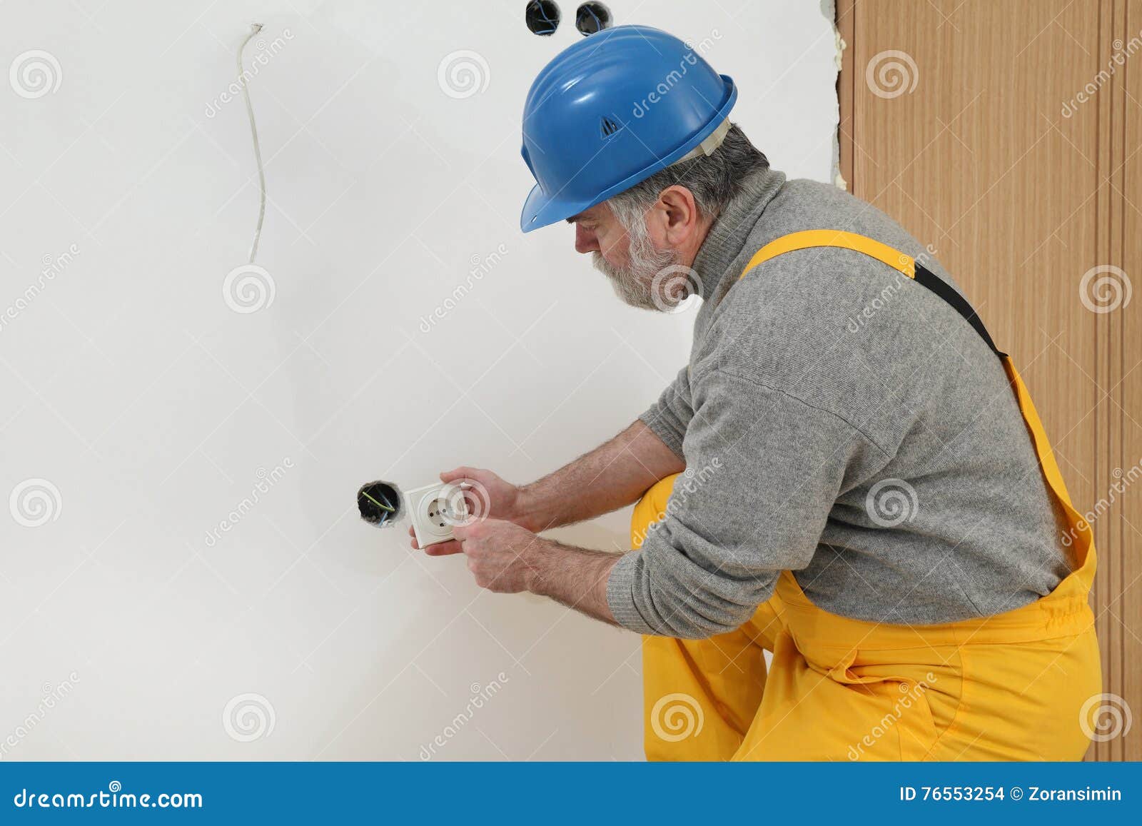 Electrician at Construction Site Install Electrical Plug Stock Photo ...