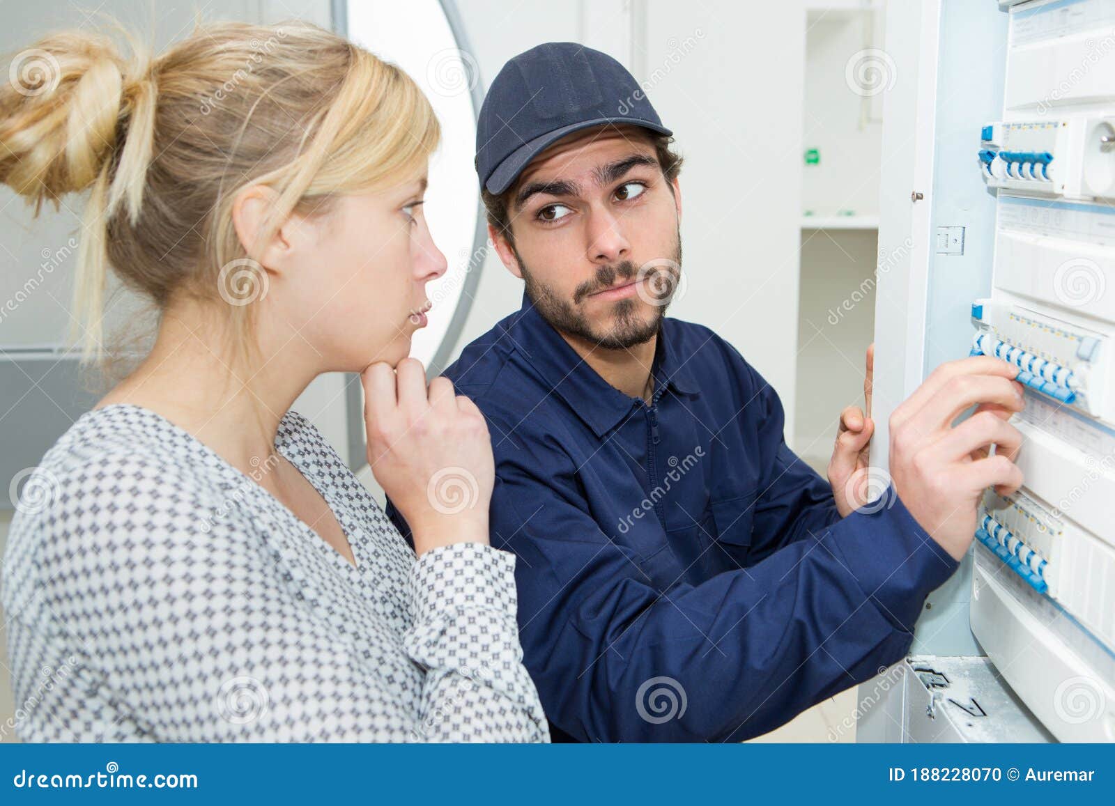 Electrician with Customer Analysing Problem in Circuit Breaker Box ...