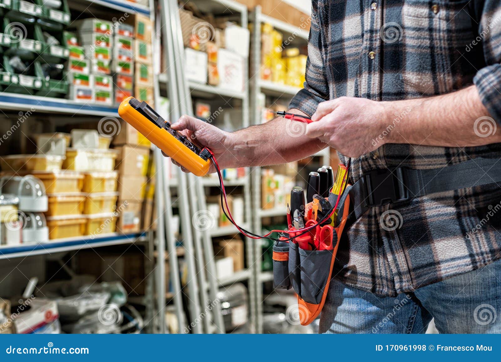 Electrician in the Store of Electrical Components. Electricity Stock ...