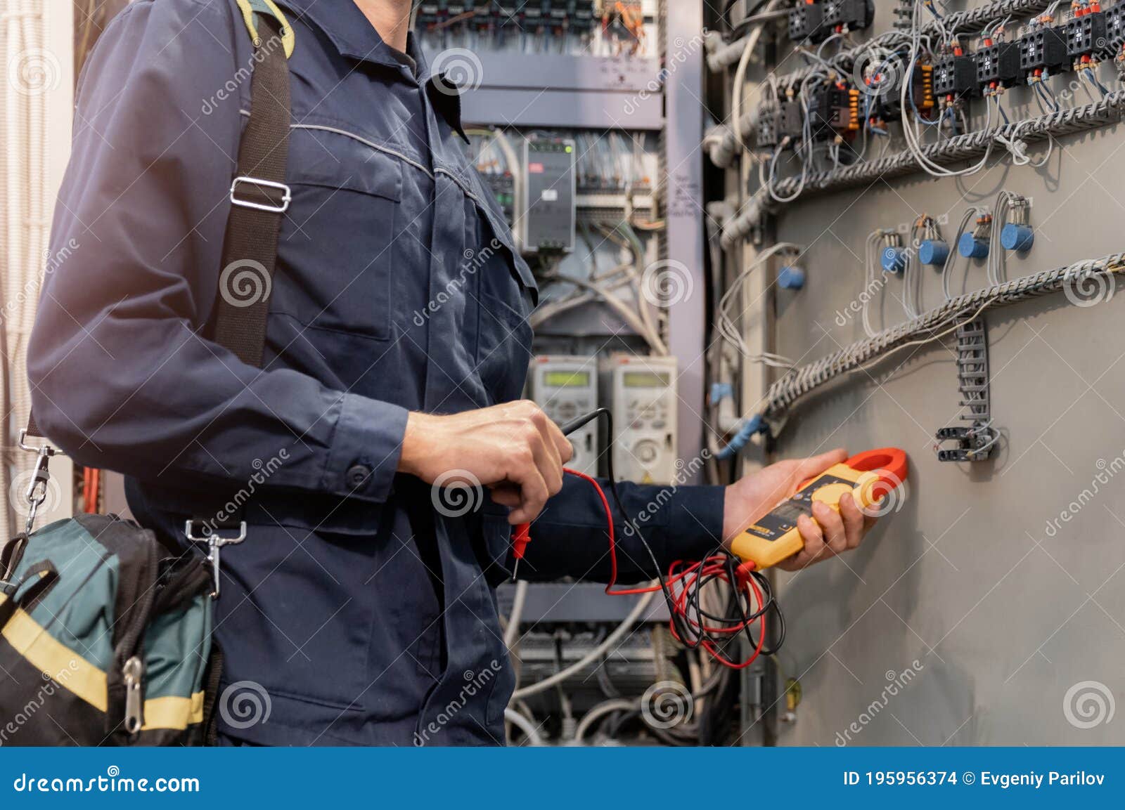 Electrician Engineer Checks Electrical Circuit in Control Panel for ...