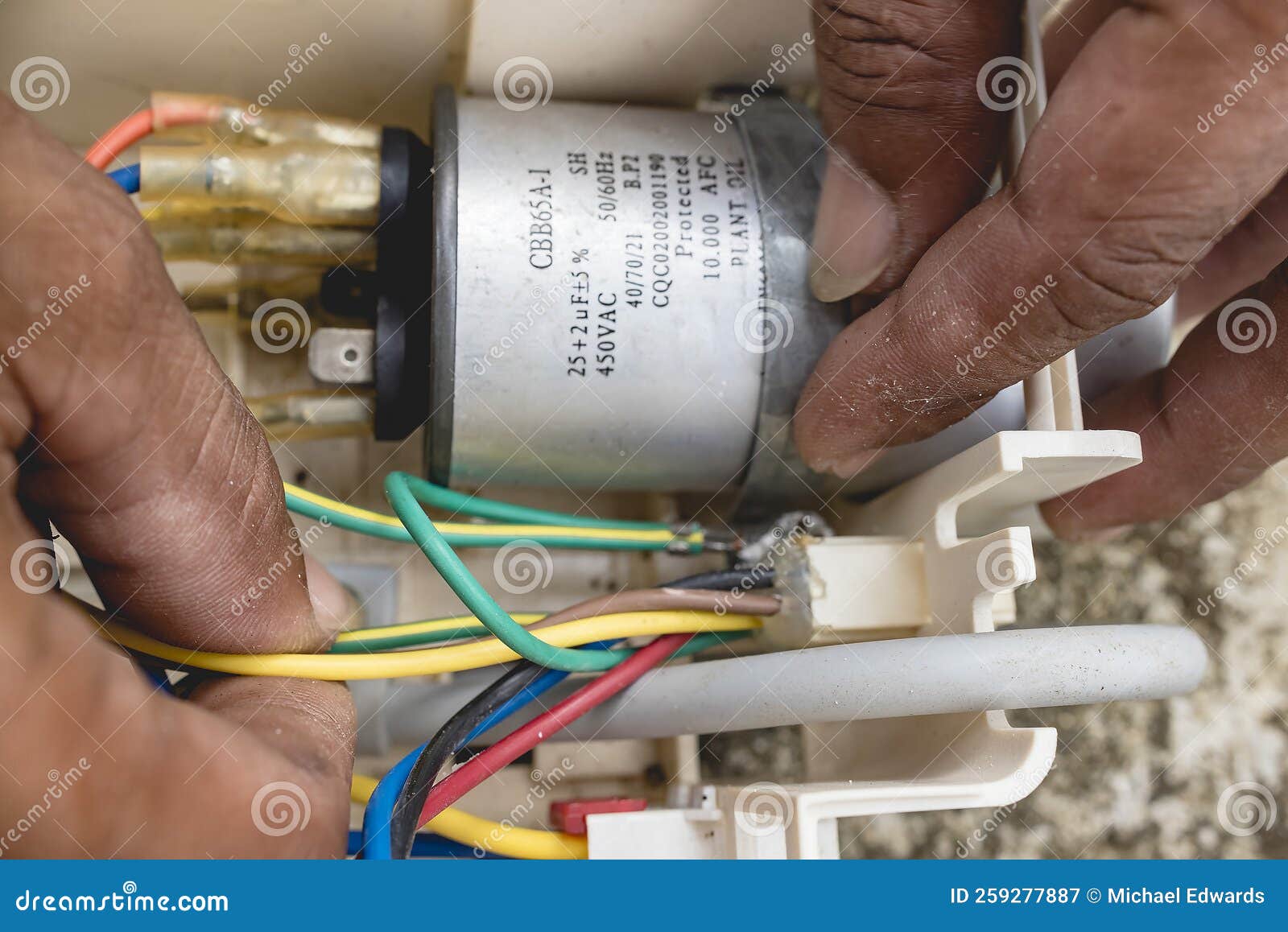 An Electrician Examines the Wiring Connected To CBB65A-1 Capacitor ...