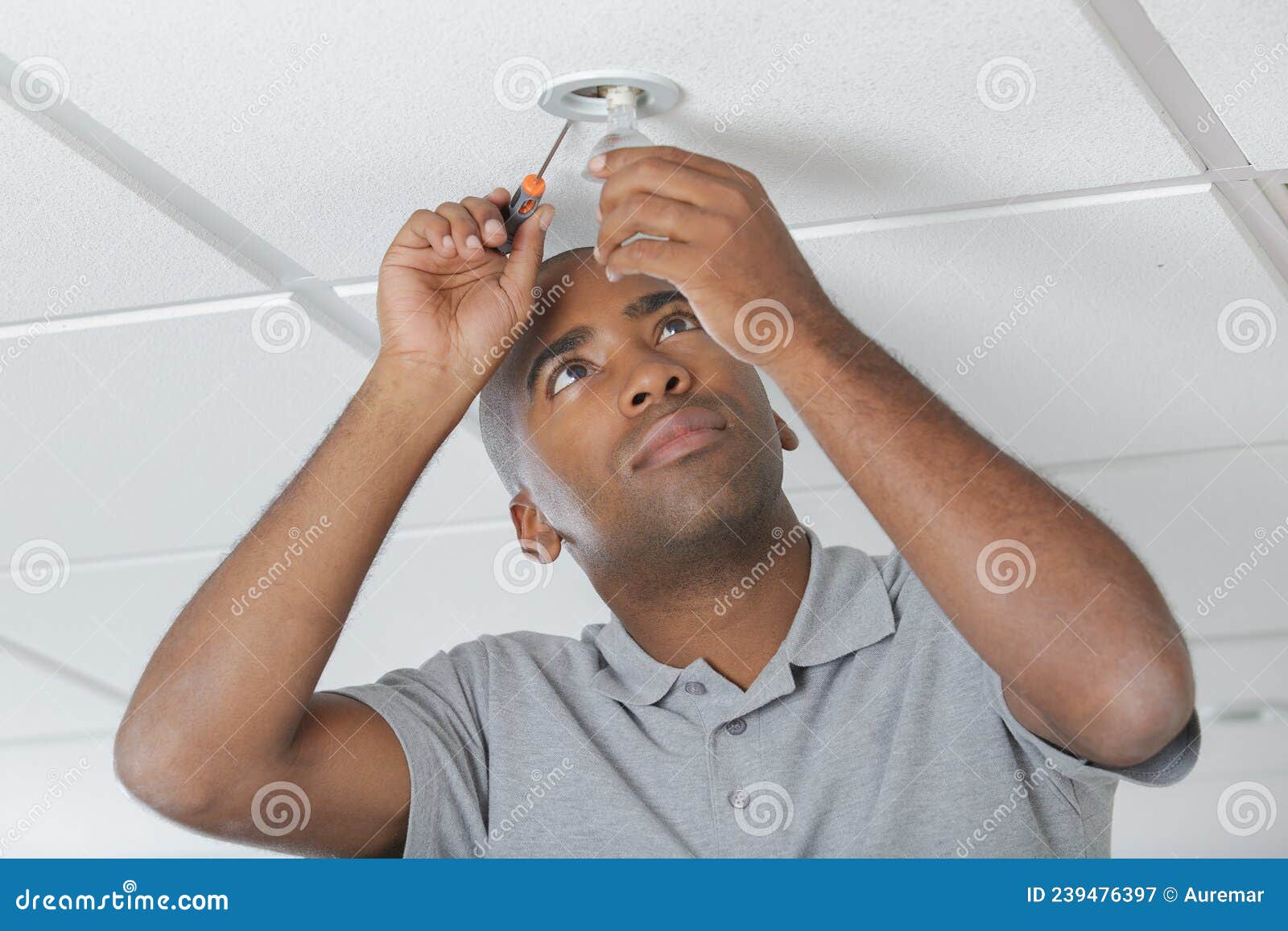 Electrician Fitting Lightbulb in Office Stock Image - Image of office ...