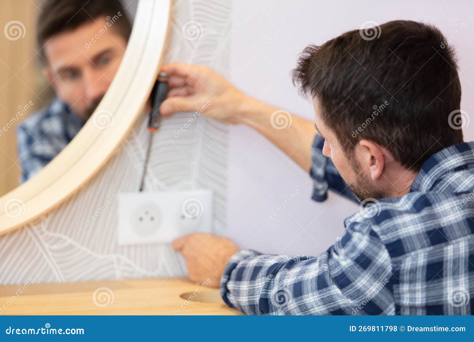 Electrician Fitting Plug Sockets on Wall in Salon Stock Photo - Image ...
