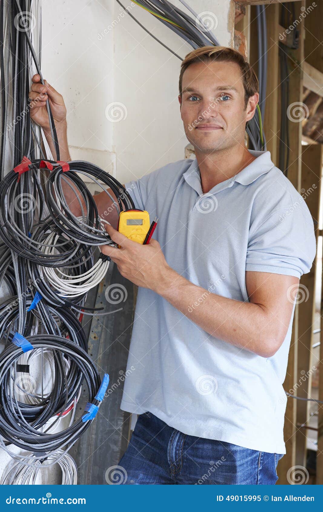 Electrician Fitting Wiring on Construction Site Stock Image - Image of ...