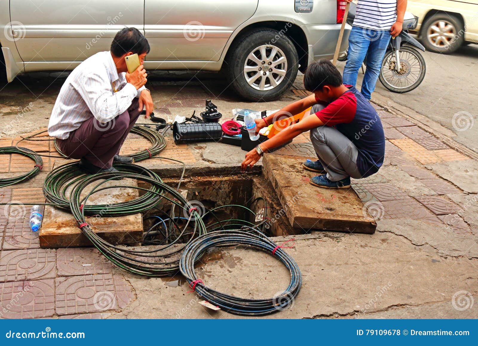 Electrician Fixing, Repairing Messy Electric Cables In Hanoi Slums ...