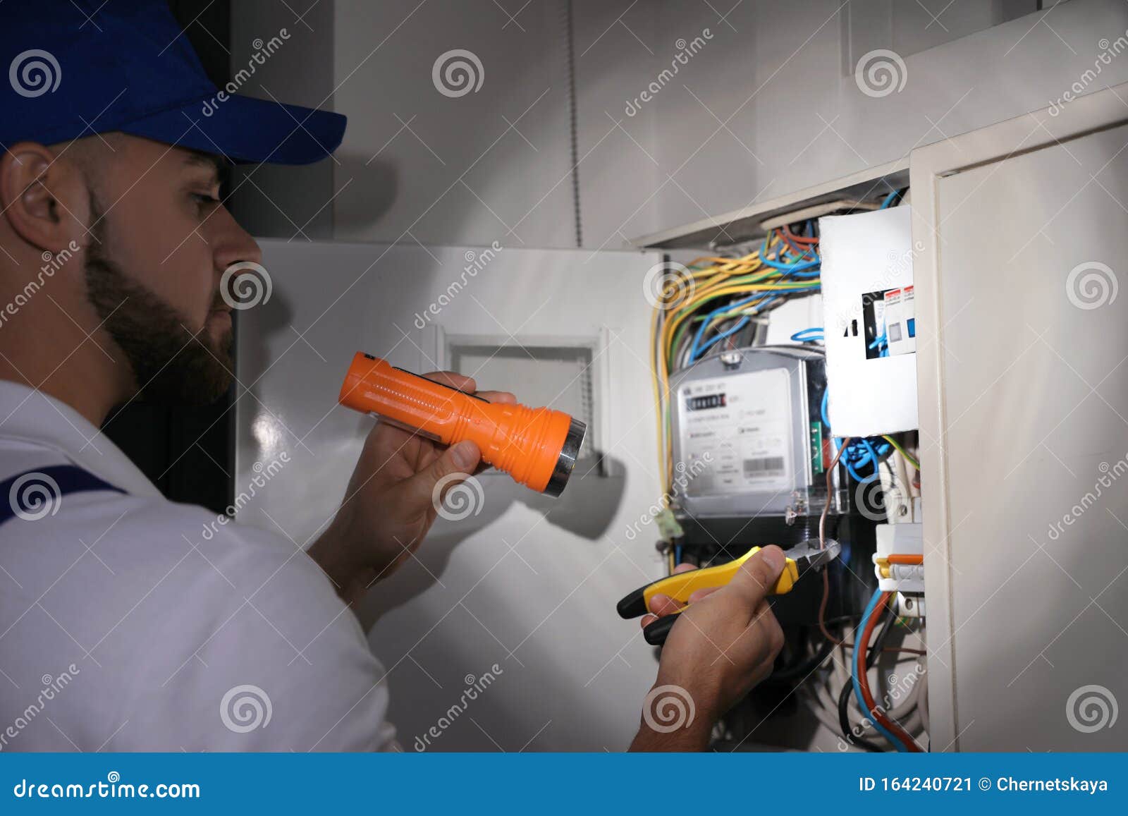 Electrician with Flashlight Fixing Electric Panel Stock Image - Image ...