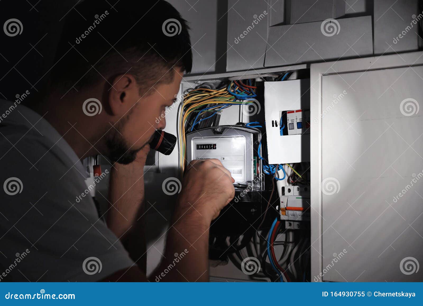 Electrician with Flashlight Fixing Electric Panel Stock Image - Image ...