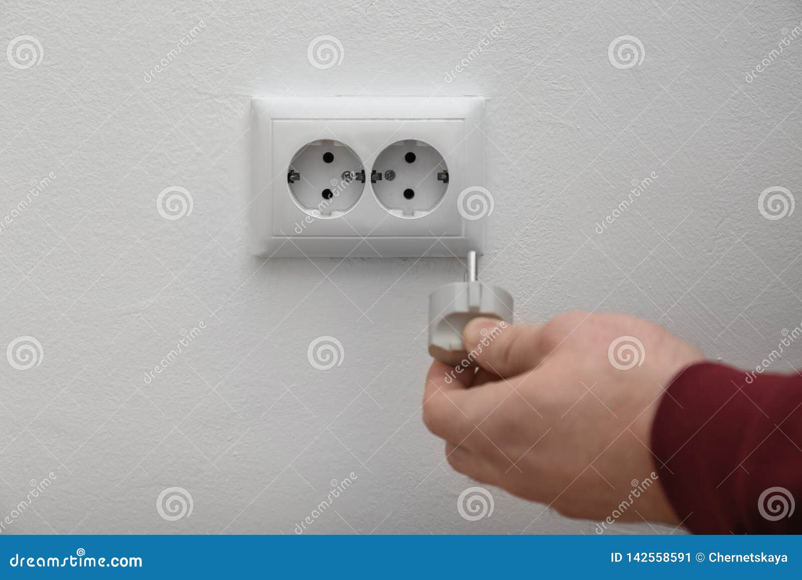 Electrician Inserting Plug into Power Socket on White, Closeup Stock ...