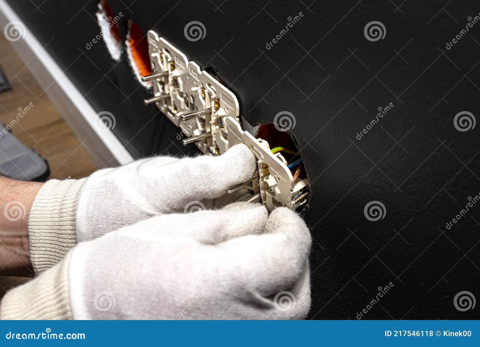 An Electrician Inserts a Double Grounded Electrical Socket into an ...