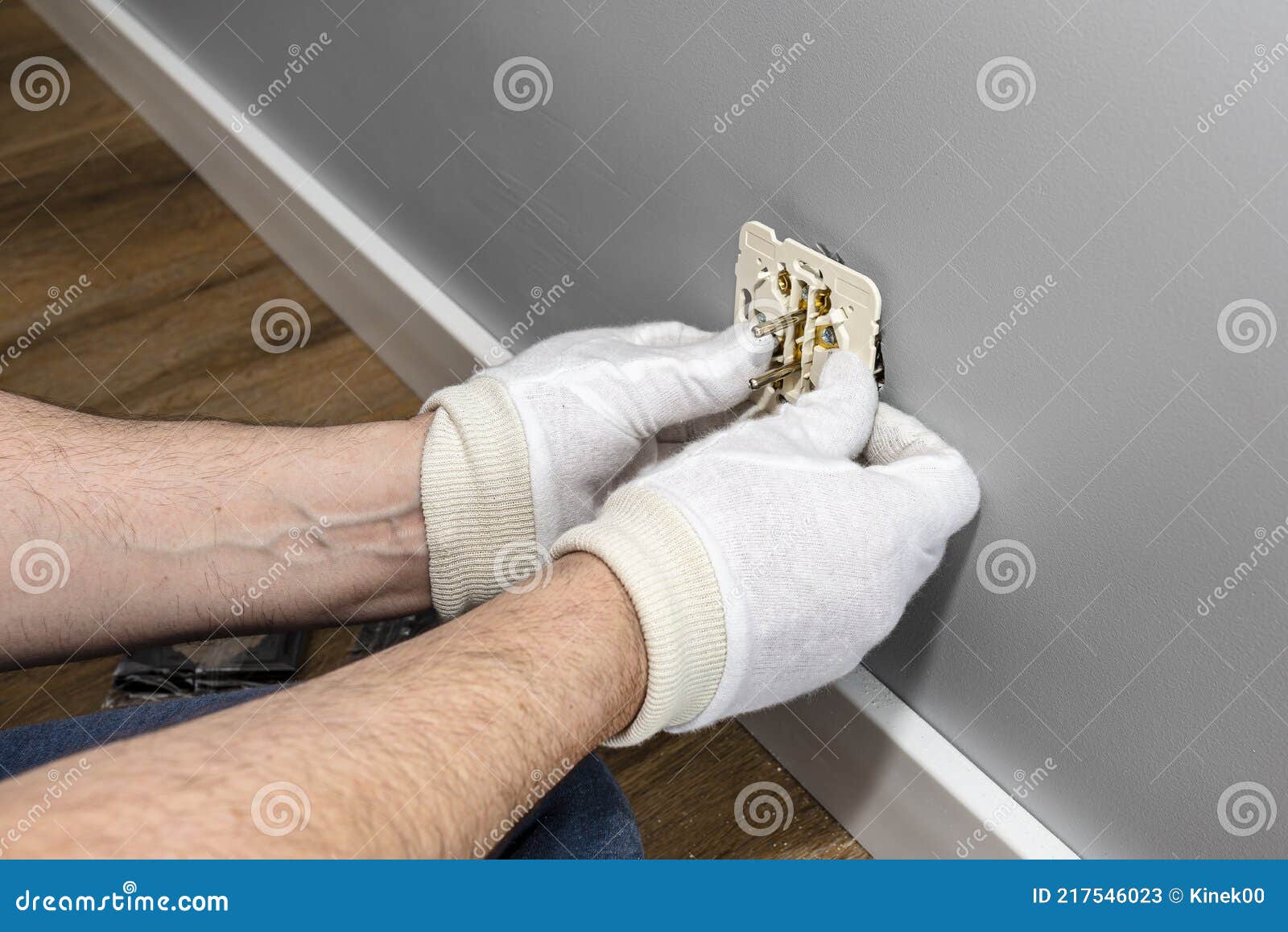 An Electrician Inserts a Double Grounded Electrical Socket into an ...