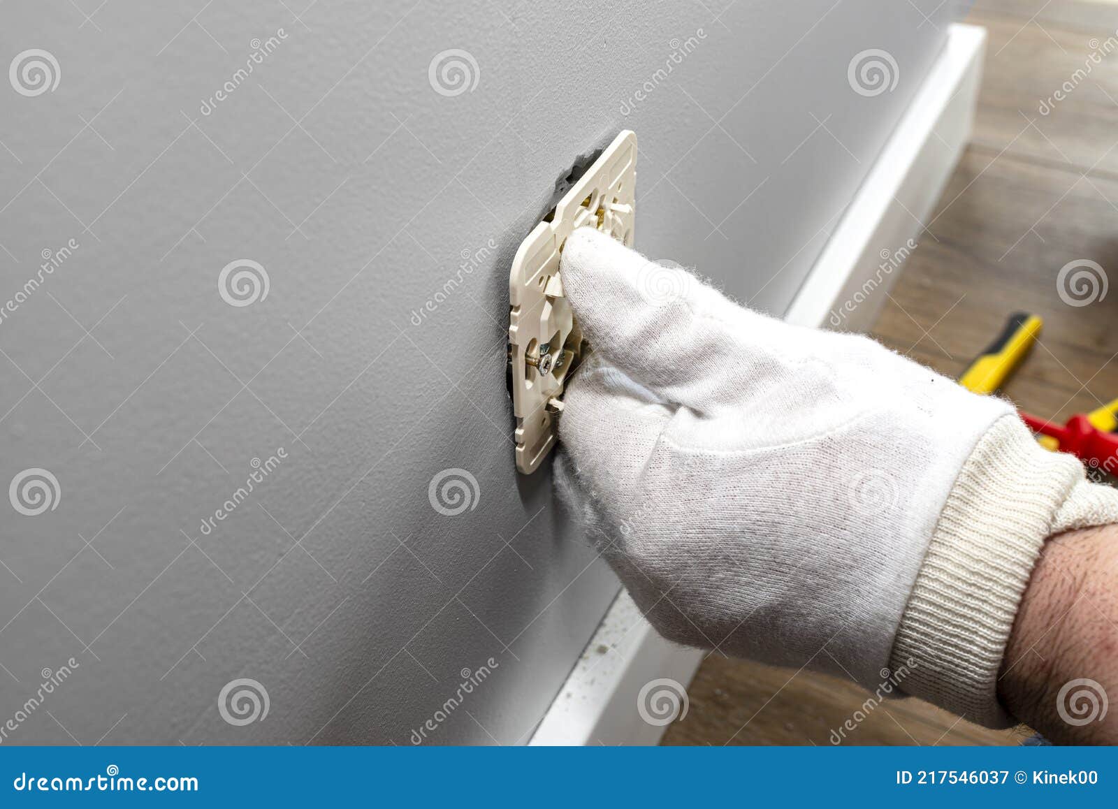 An Electrician Inserts a Double Grounded Electrical Socket into an ...