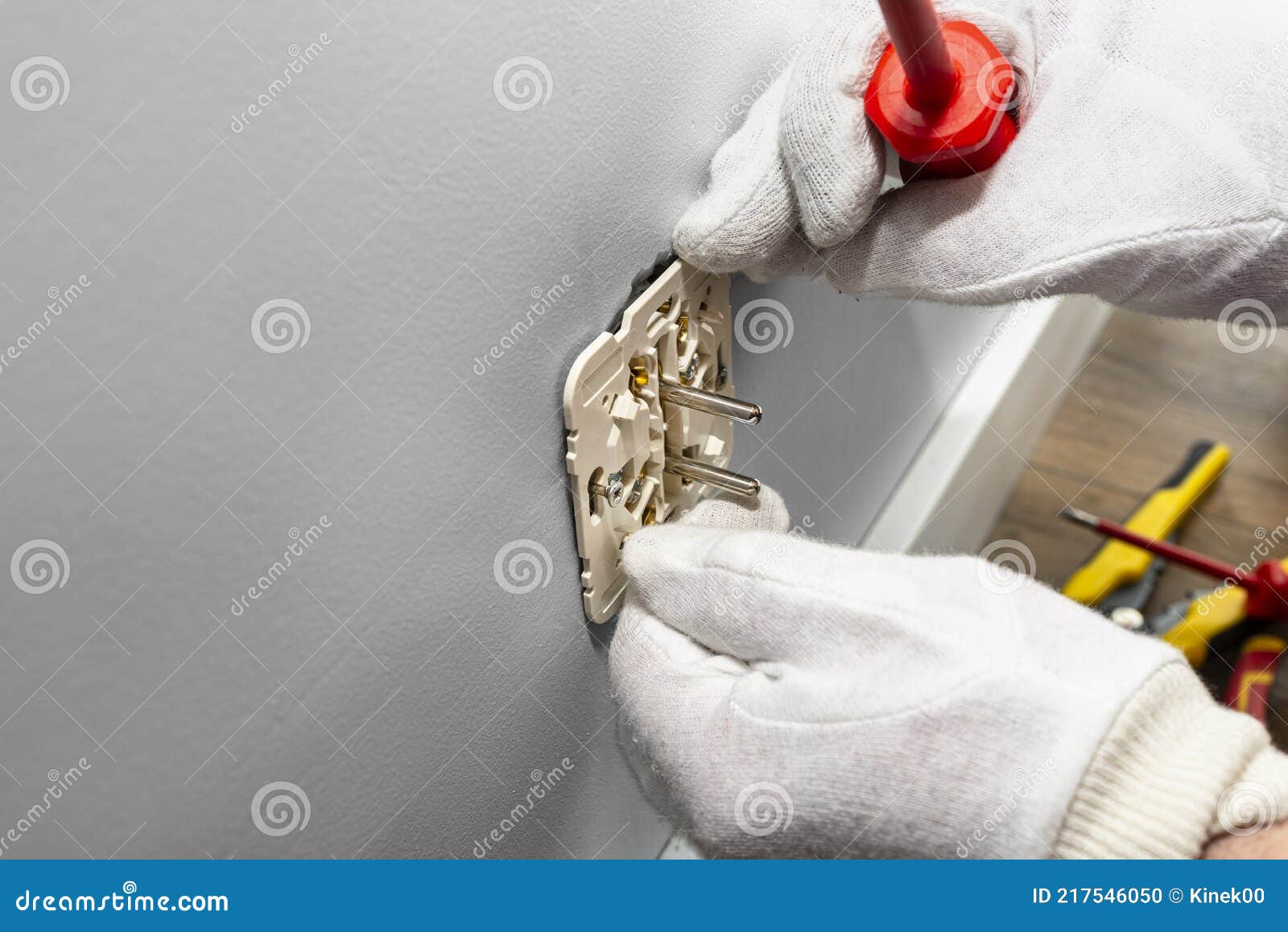 An Electrician Inserts a Double Grounded Electrical Socket into an ...