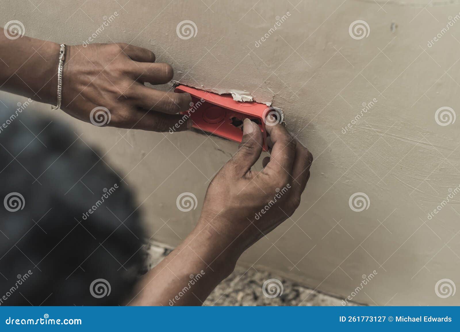 An Electrician Inserts A Double Grounded Electrical Socket Into An ...