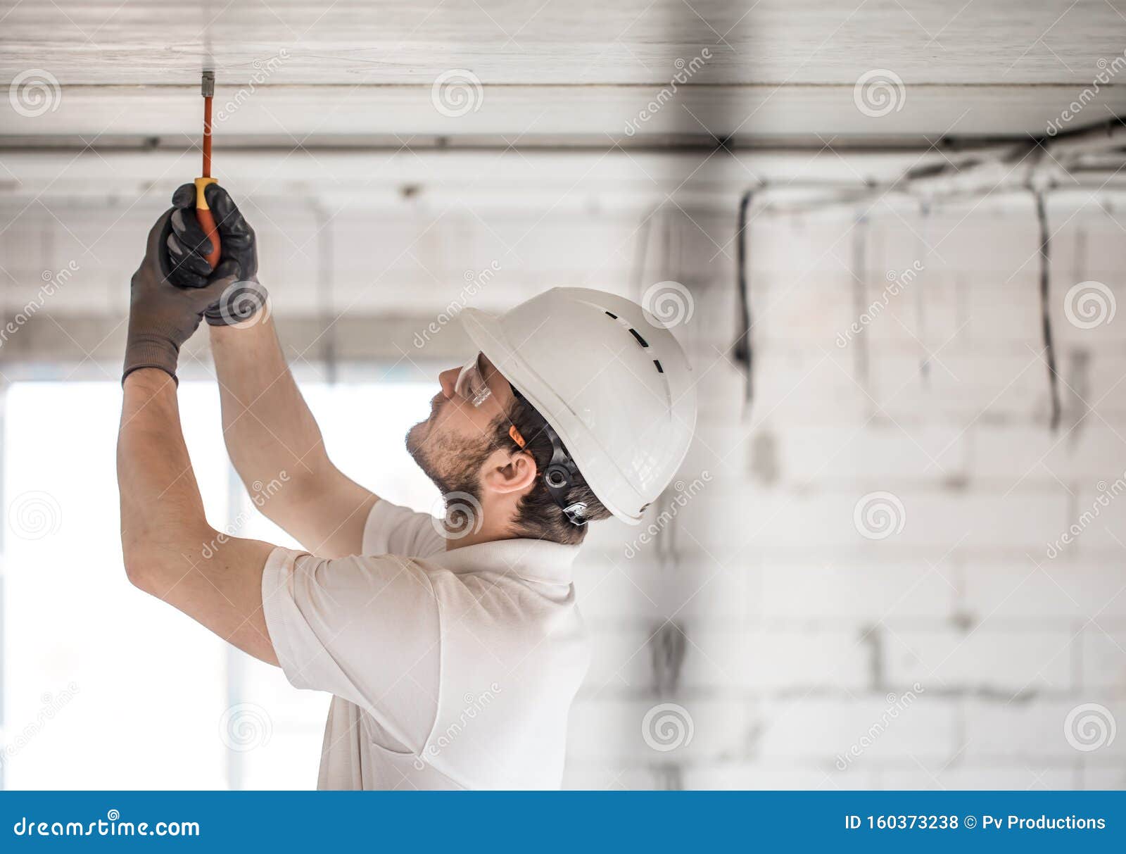 Electrician Installer with a Tool in His Hands, Working with Cable on ...