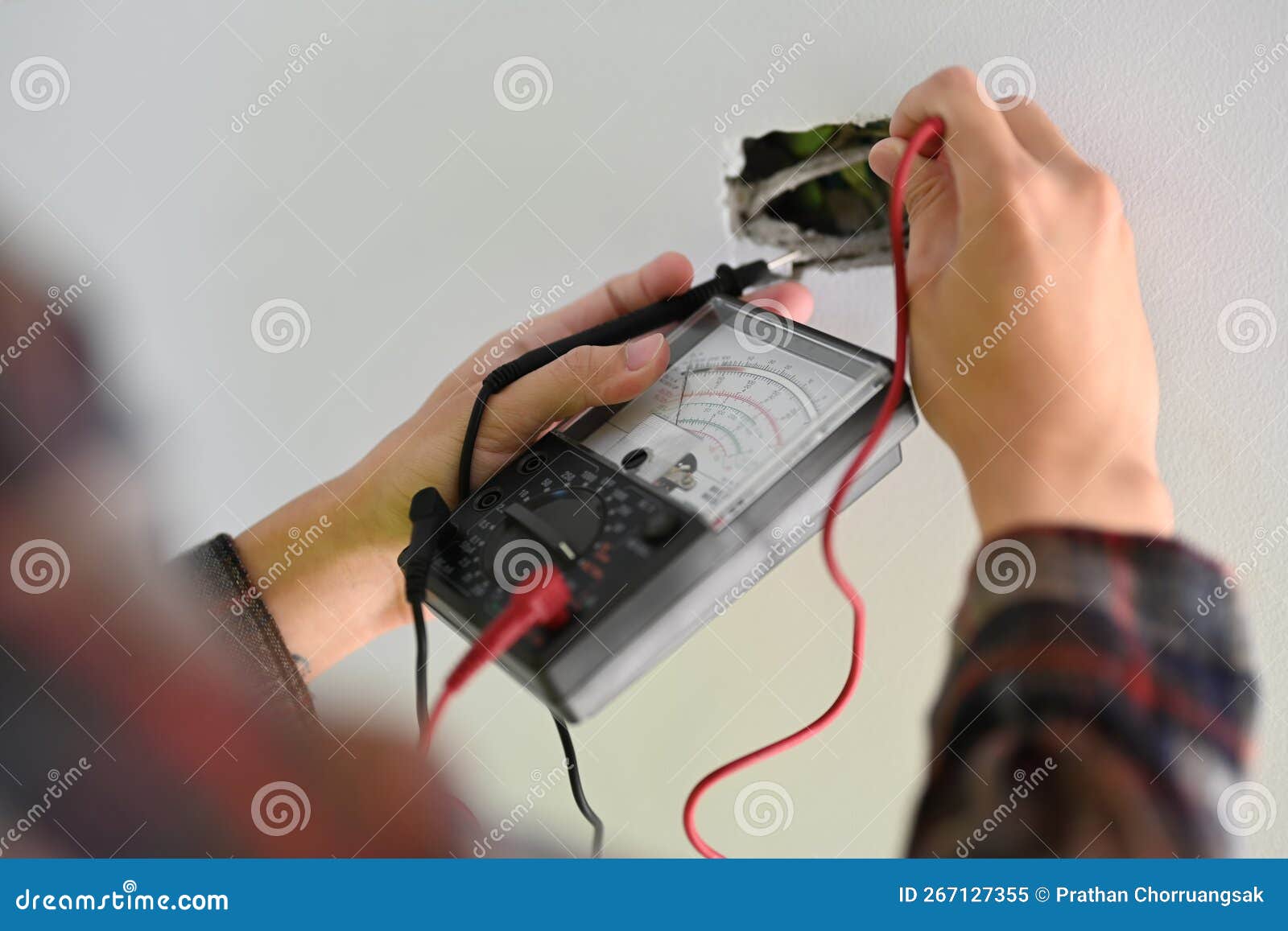 Electrician Installer Using a Multimeter To Test Power Line Current in ...