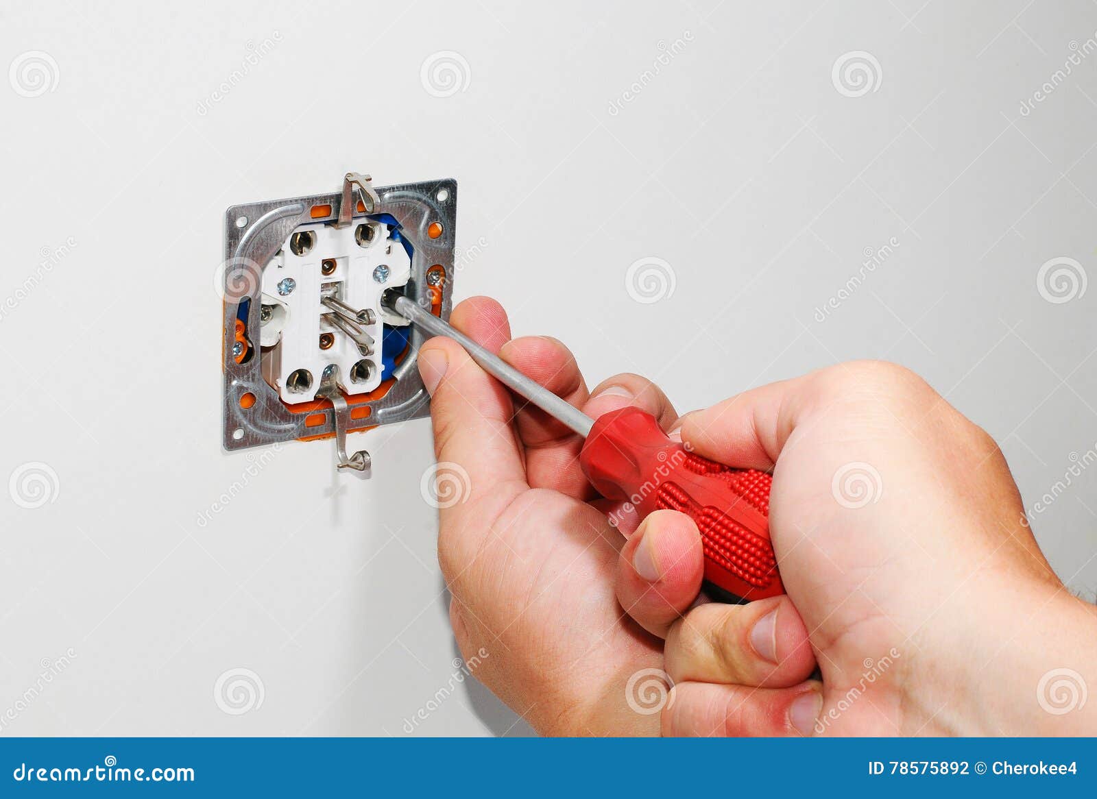 Electrician Installing A Grey Wall-mounted AC Power Socket With A ...