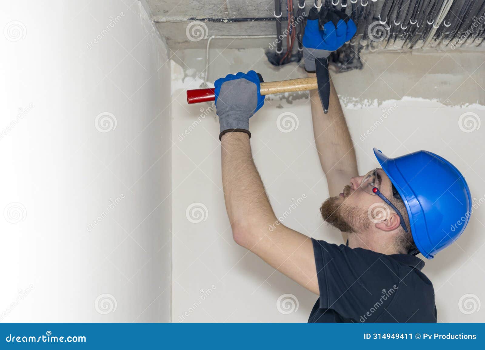 Electrician Installing Laying Electrical Cables on the Ceiling Inside ...