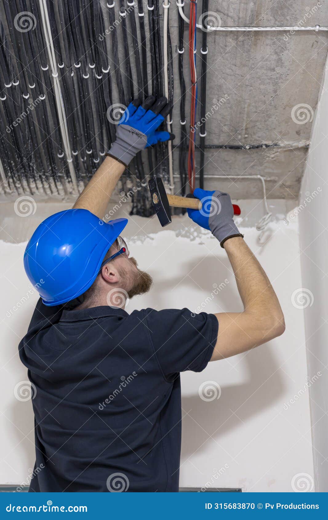 Electrician Installing Laying Electrical Cables on the Ceiling Inside ...