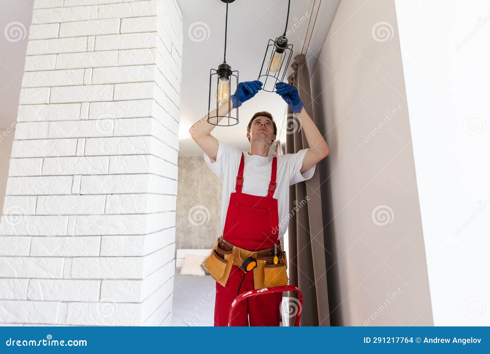 An Electrician is Installing LED Spotlights on the Ceiling. Stock Photo ...