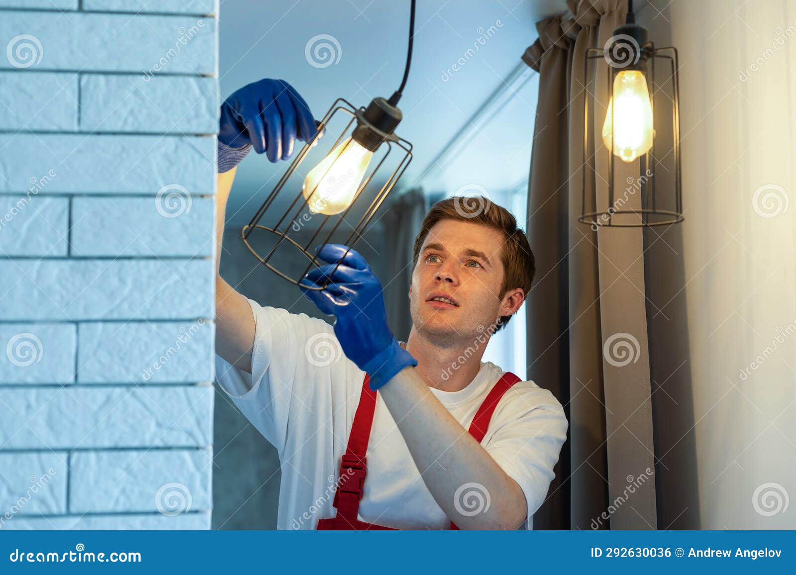 An Electrician is Installing LED Spotlights on the Ceiling. Stock Photo ...