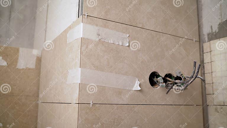 Electrician Installing Light Switch and Socket on Bathroom Tiled Walls. Stock Image - Image of ...