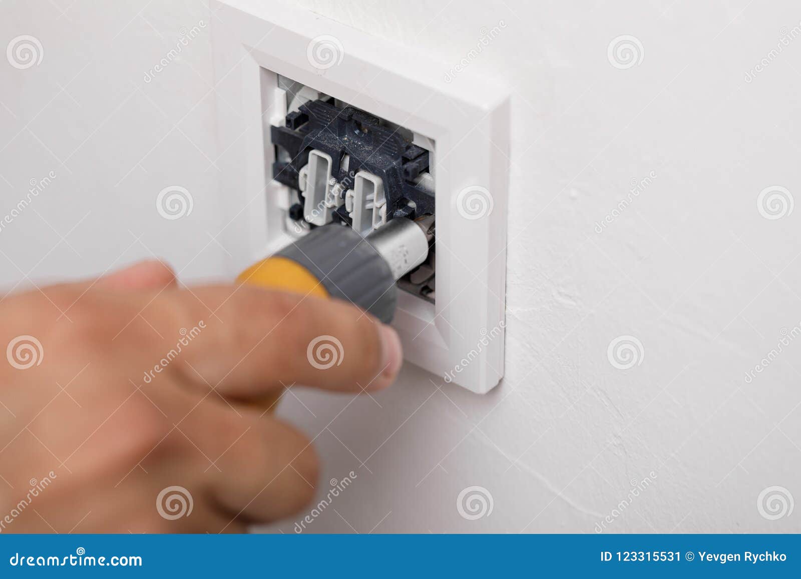 The Electrician Installing the Light Switch. Tool Stock Image - Image ...