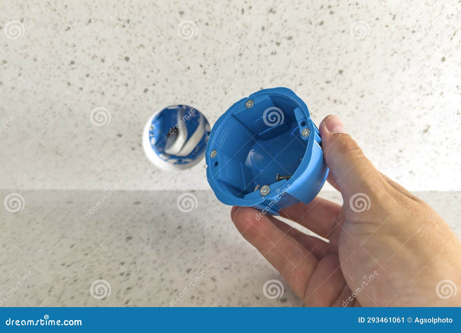 An Electrician Installs a Socket in the Kitchen. Hands of a Qualified ...