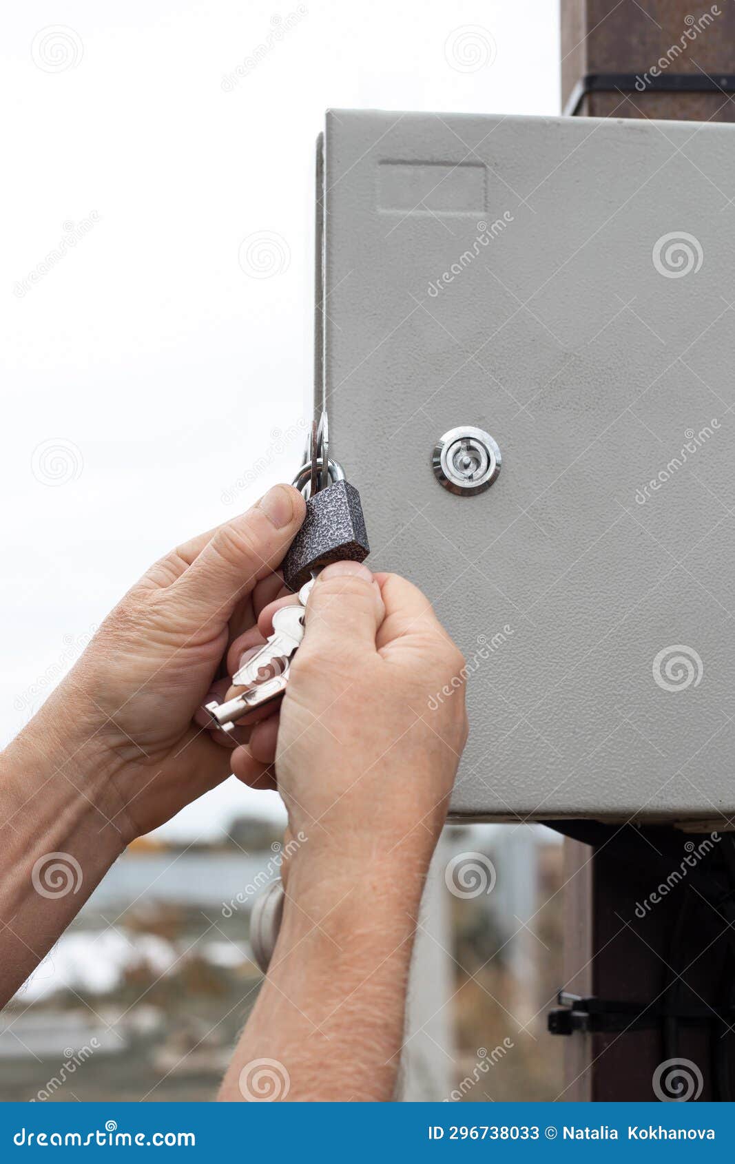 An Electrician Locks an Electrical Panel with Automatic Switches ...