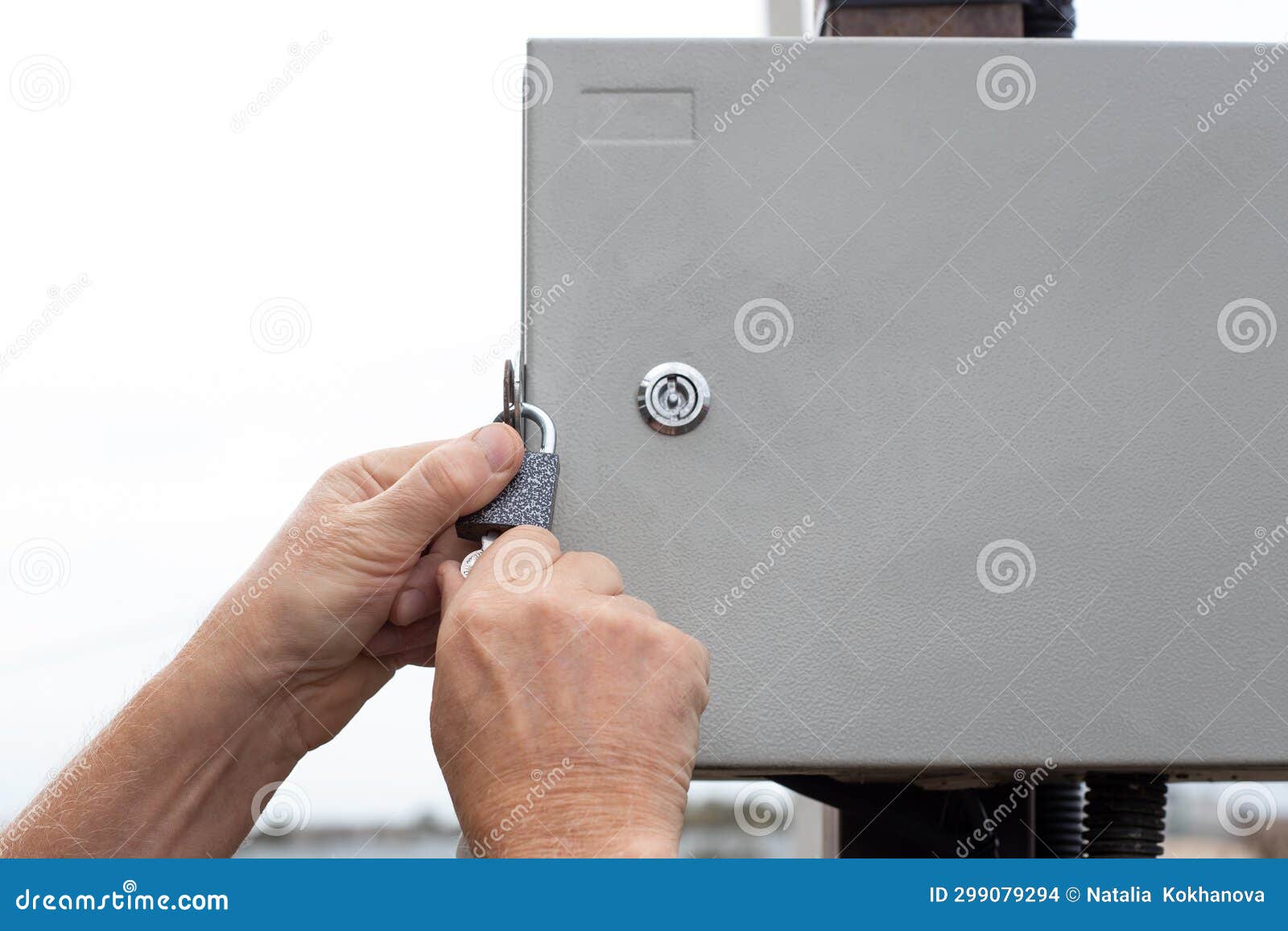 An Electrician Locks an Electrical Panel with Automatic Switches ...