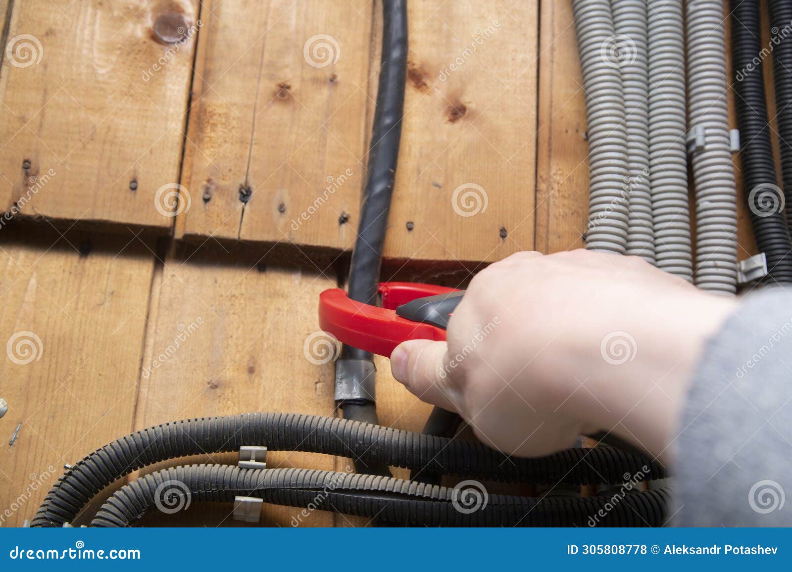 An Electrician Measures the Current Strength Using a Special Device ...