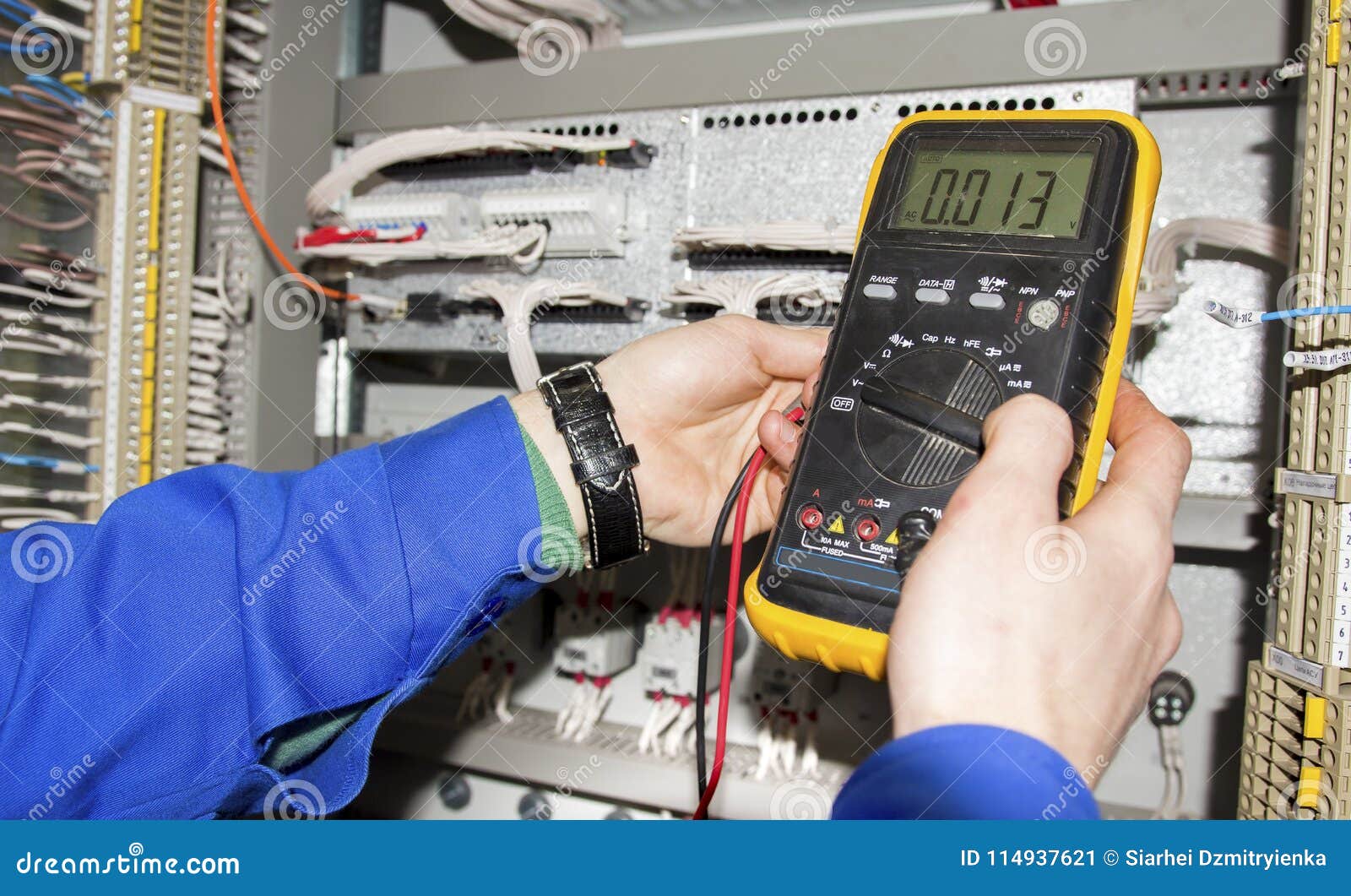 Electrician Measures Voltage by Tester. Multimeter is in Hands of ...